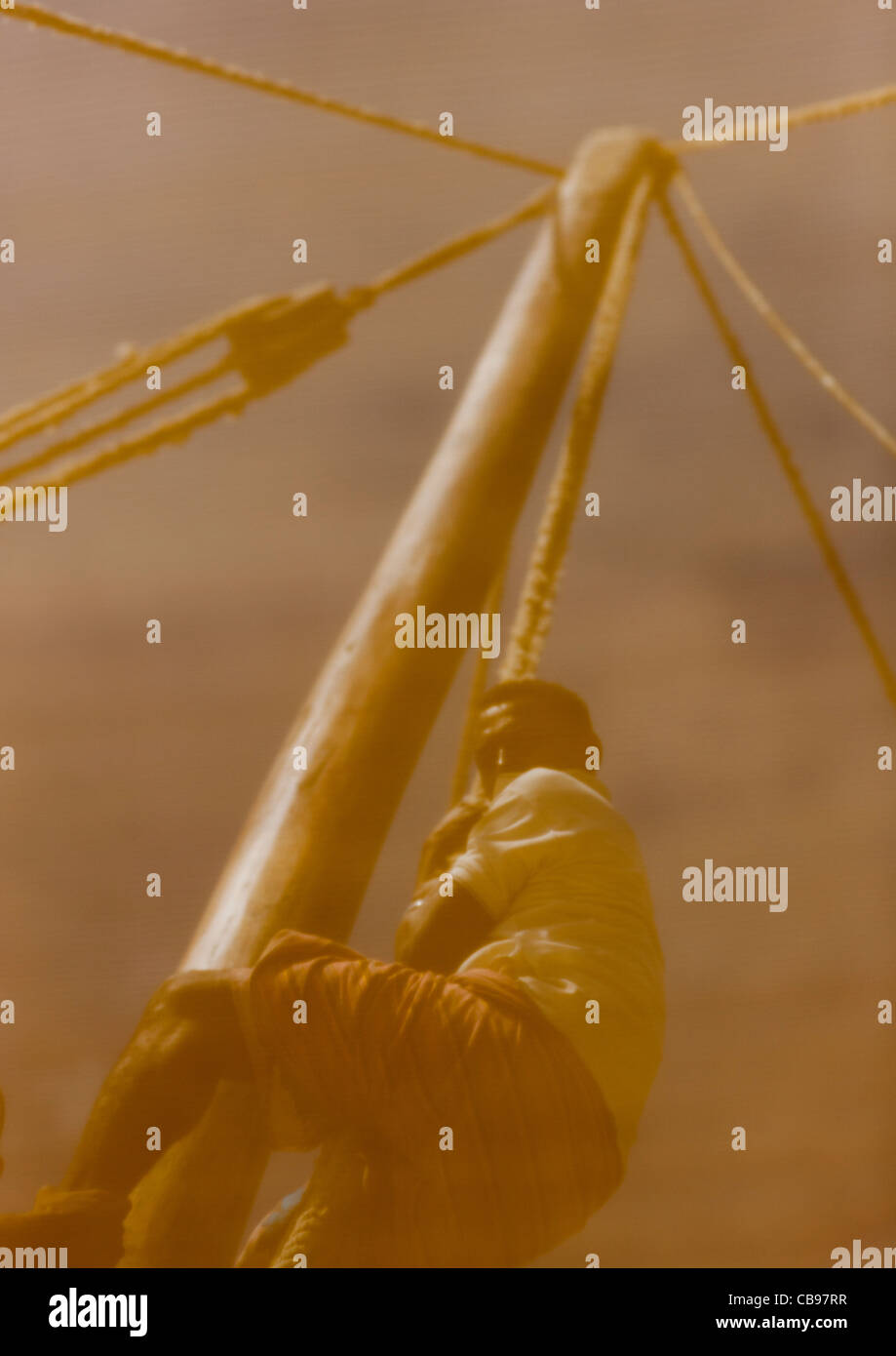 Lamu Kenya Africa swahili man hoisting sail during dhow race maulidi ...