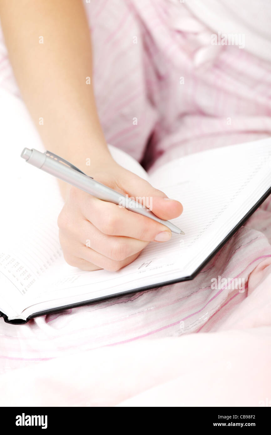 Woman taking notes in a diary - diary closeup Stock Photo - Alamy