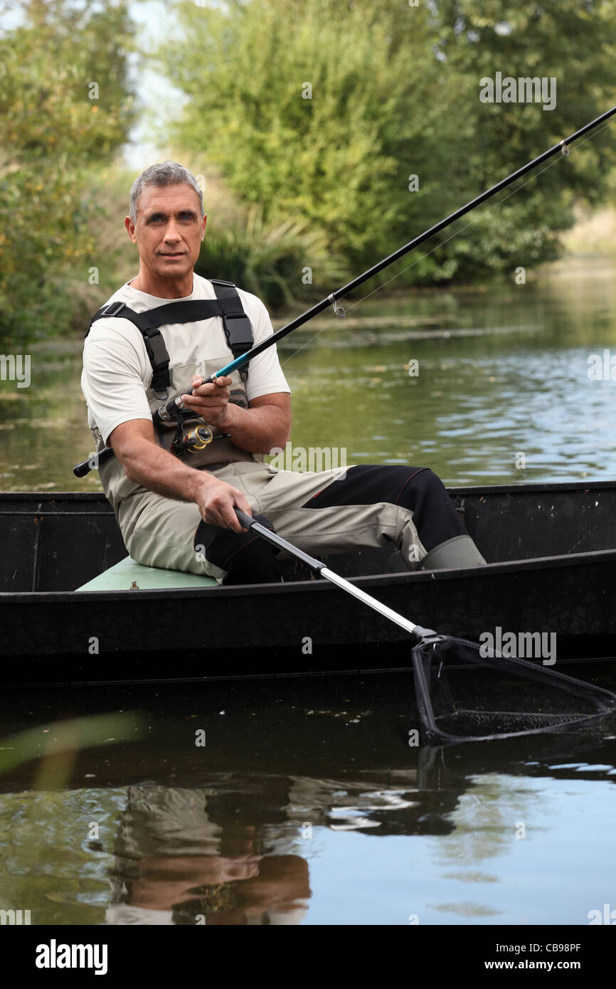 Fisherman in a boat Stock Photo - Alamy