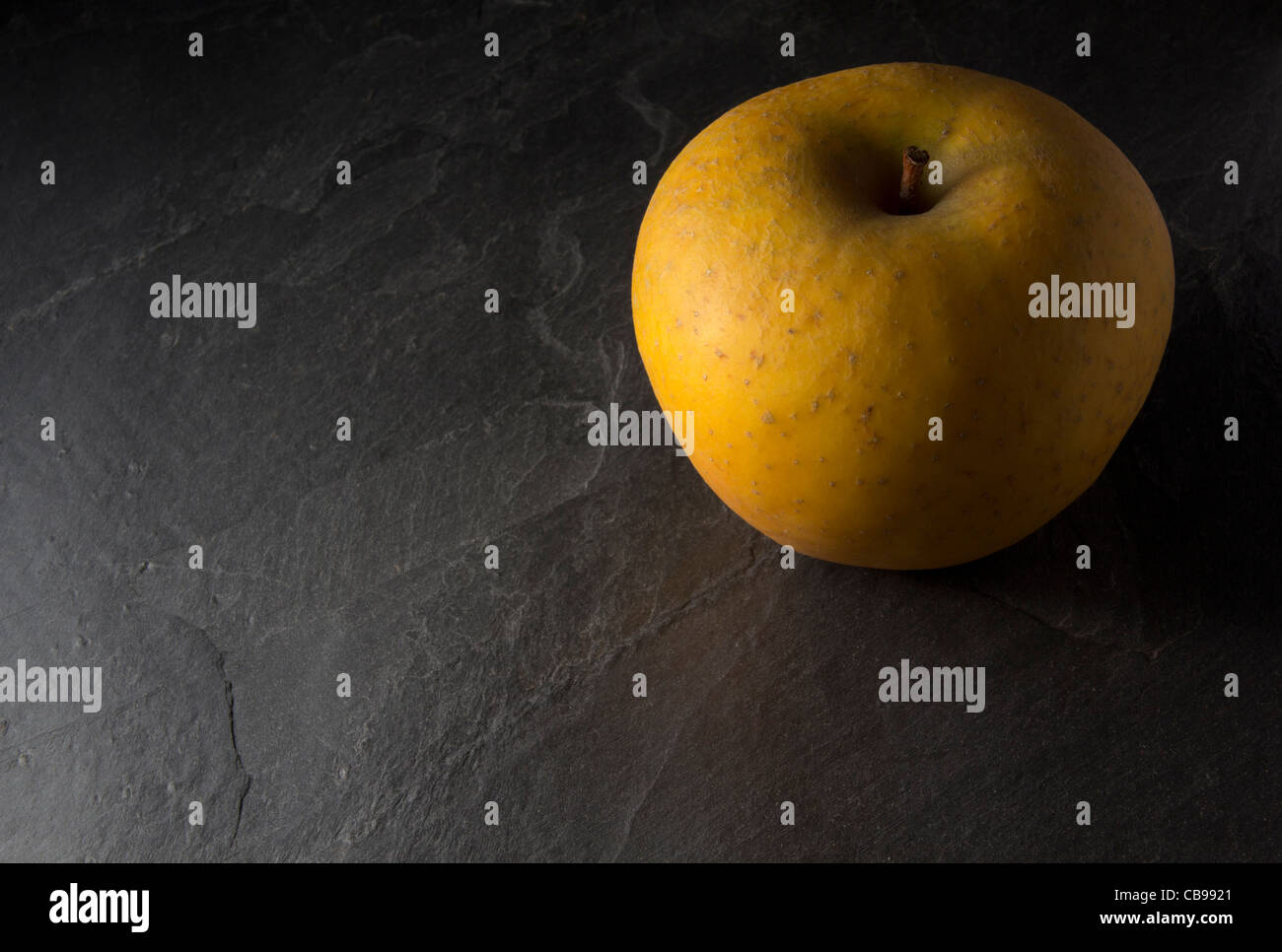 Apple on slate Stock Photo - Alamy
