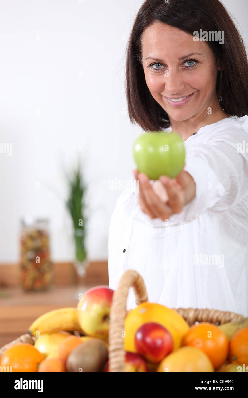 Woman giving apple Stock Photo - Alamy