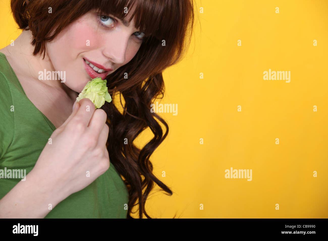 Woman eating iceberg lettuce Stock Photo - Alamy