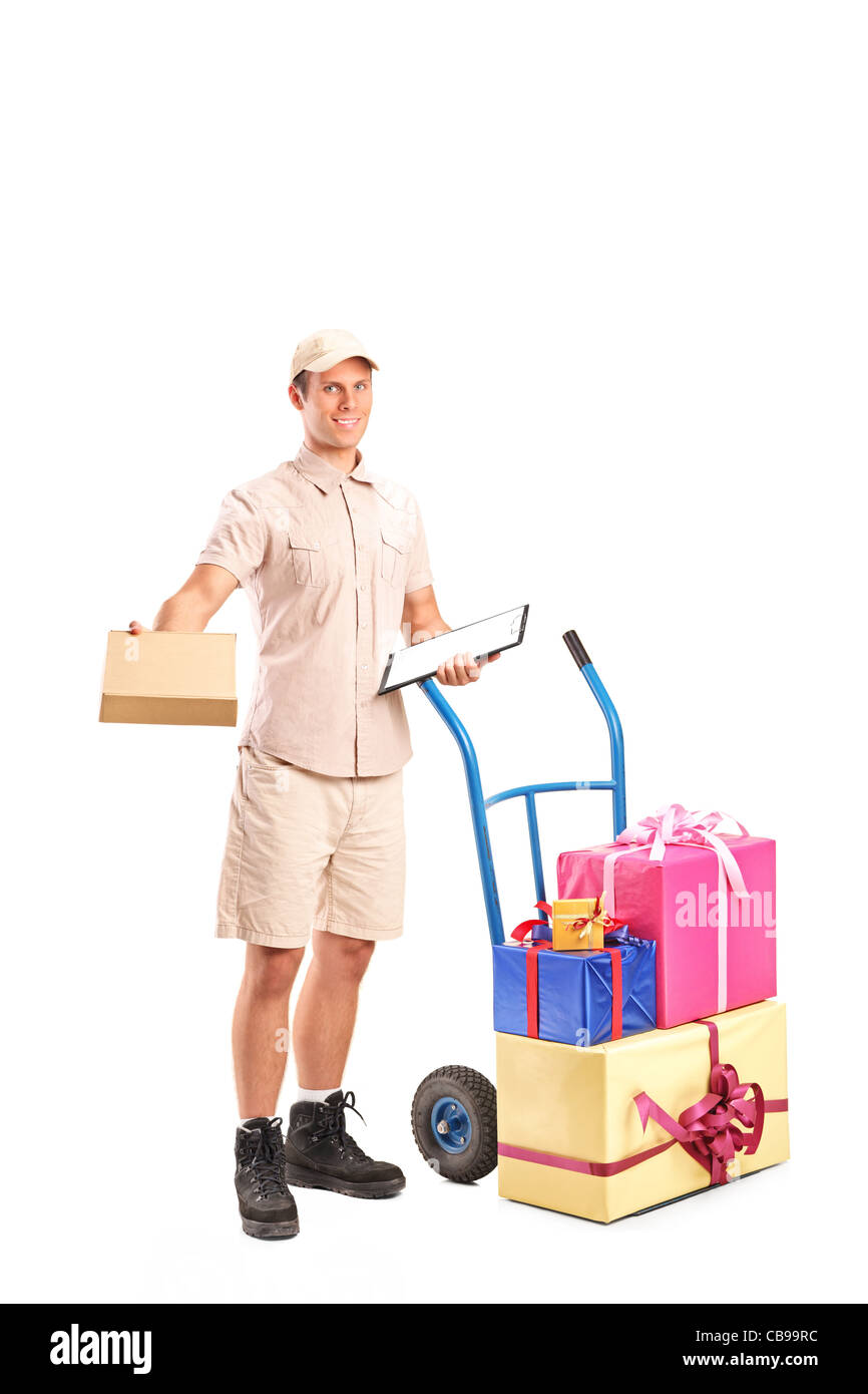 Full length portrait of a delivery person posing next to a hand truck ...