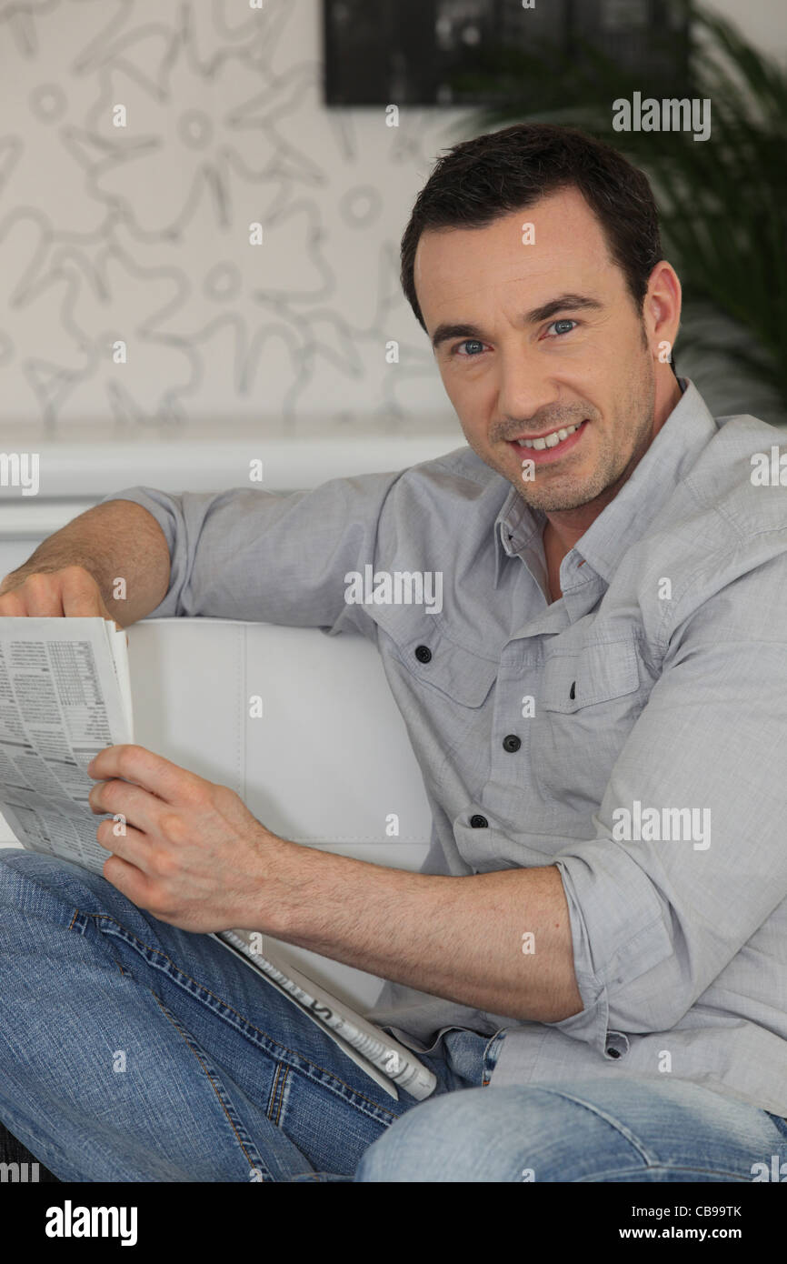 Man reading the newspaper at home Stock Photo - Alamy