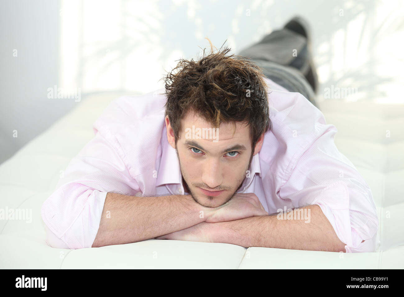 Man laying in bed Stock Photo - Alamy