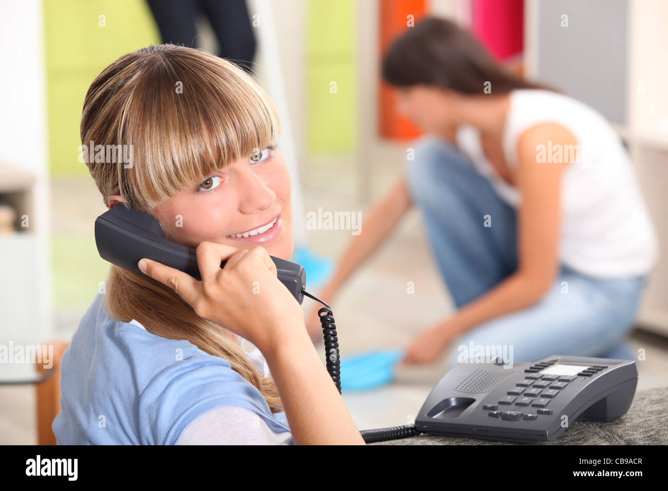 A teenage girl answering the phone at her place Stock Photo - Alamy