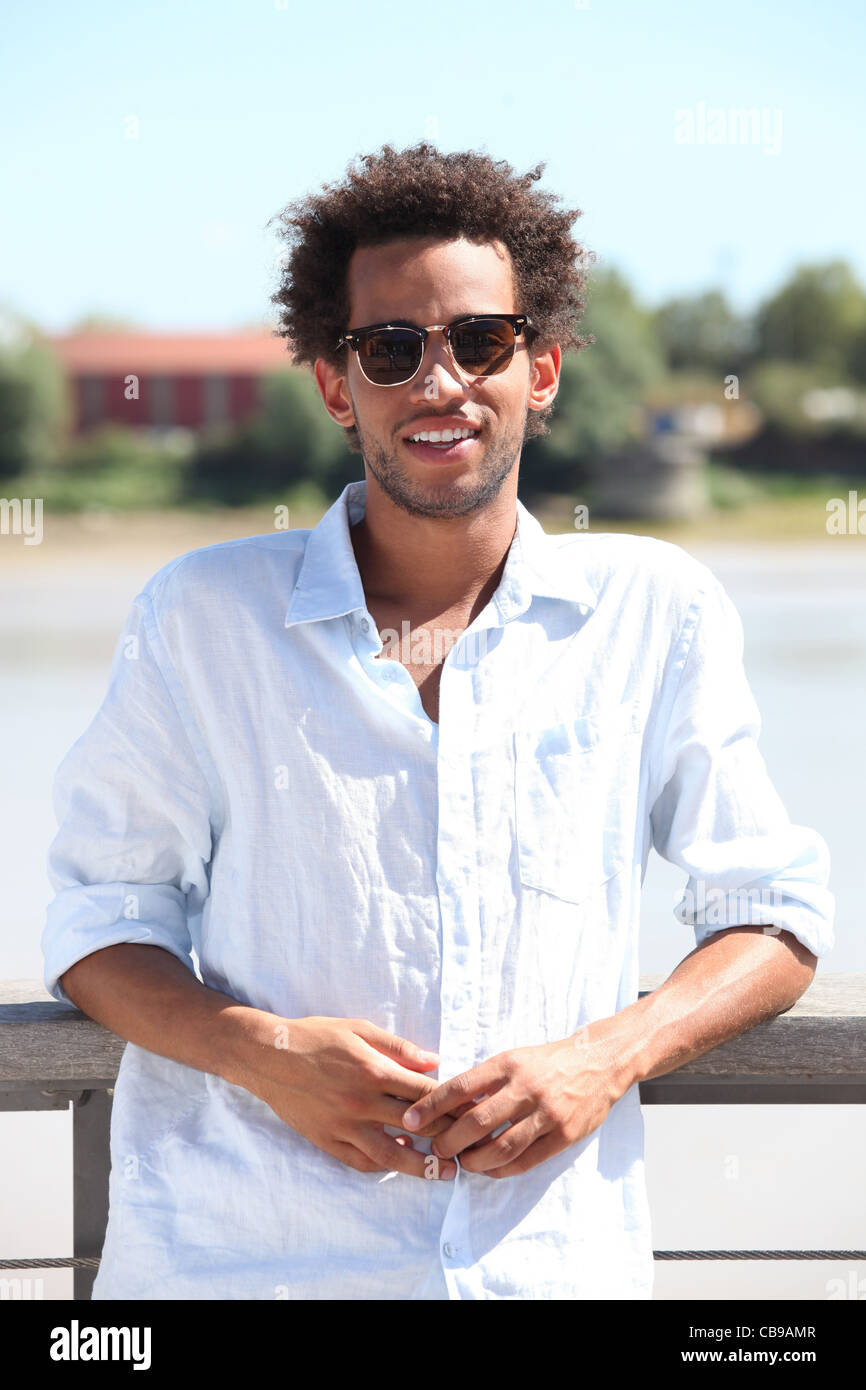 Man stood by waterfront Stock Photo - Alamy