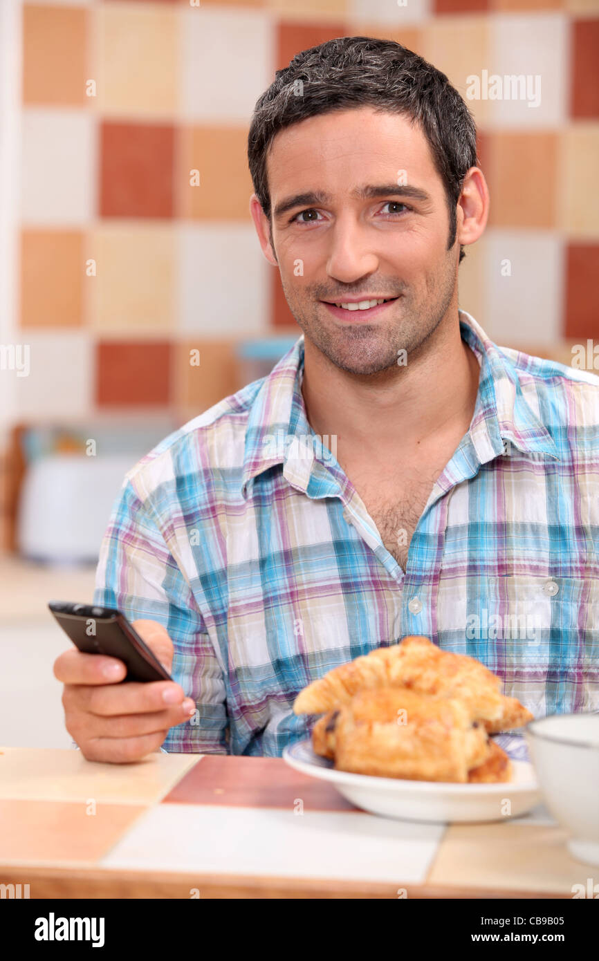 Man texting over breakfast Stock Photo - Alamy