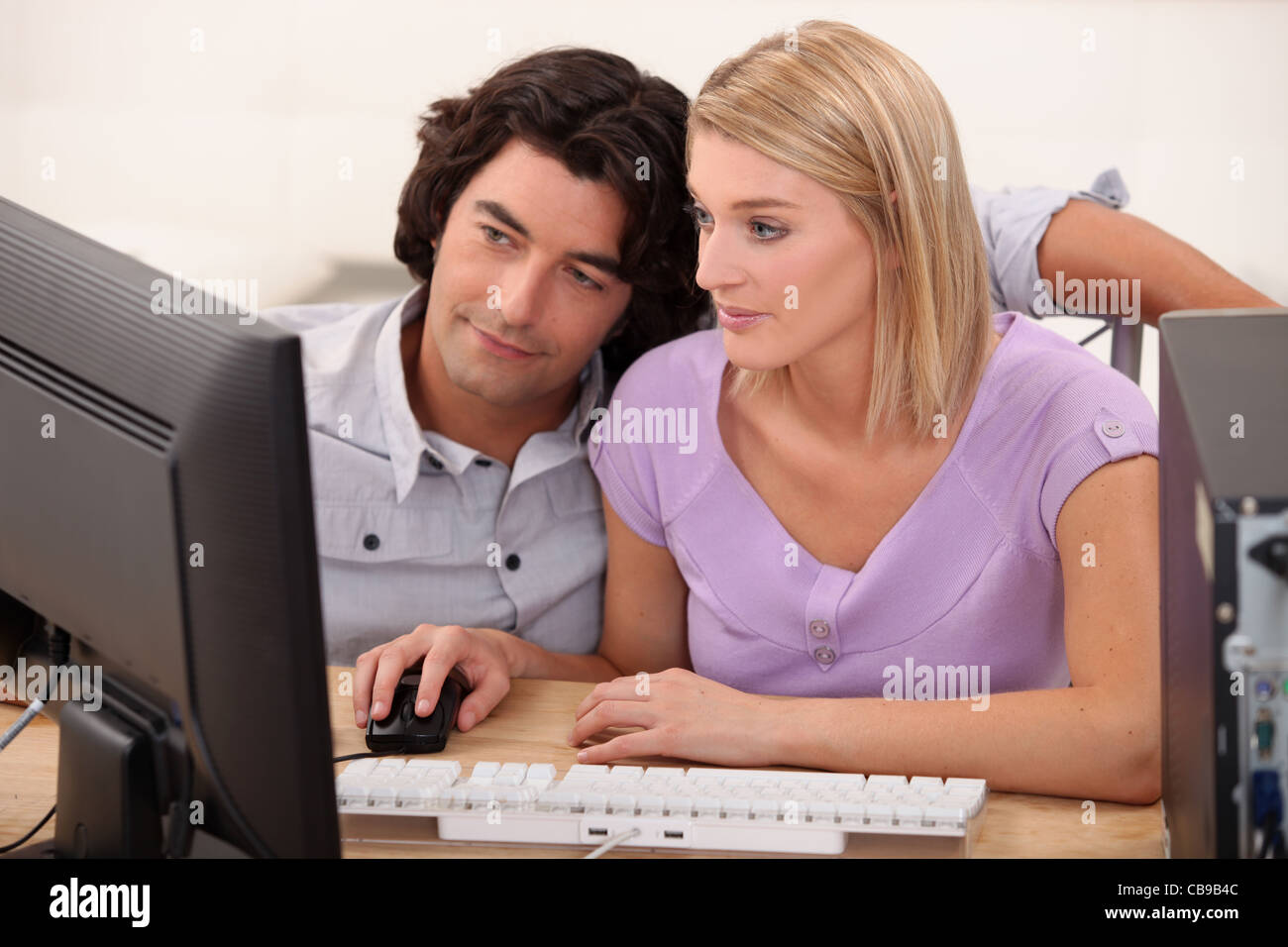 Couple looking at a computer together Stock Photo - Alamy