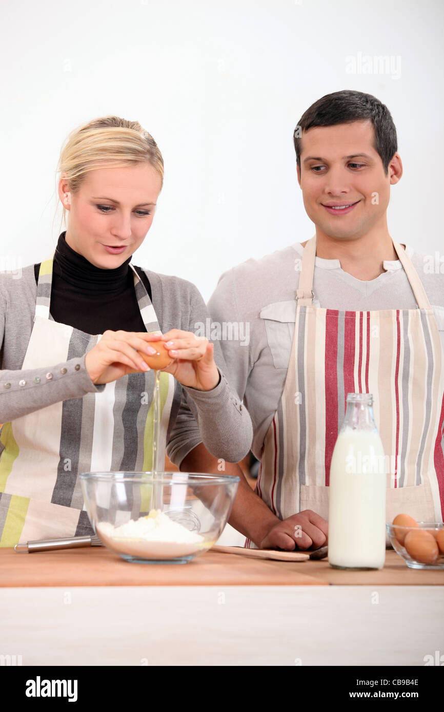 a woman and a boy making a cake Stock Photo - Alamy