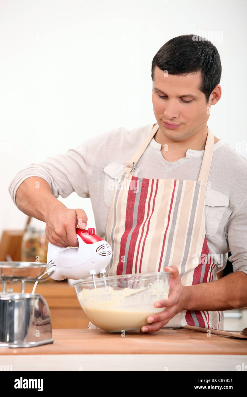 Man using electric whisk Stock Photo - Alamy