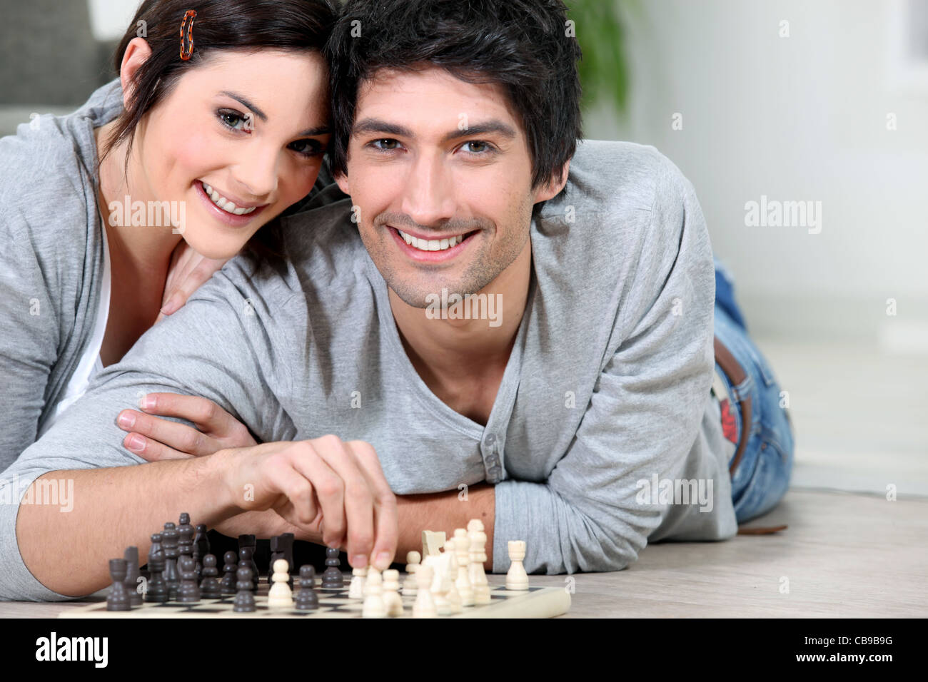 Attractive couple playing chess Stock Photo - Alamy