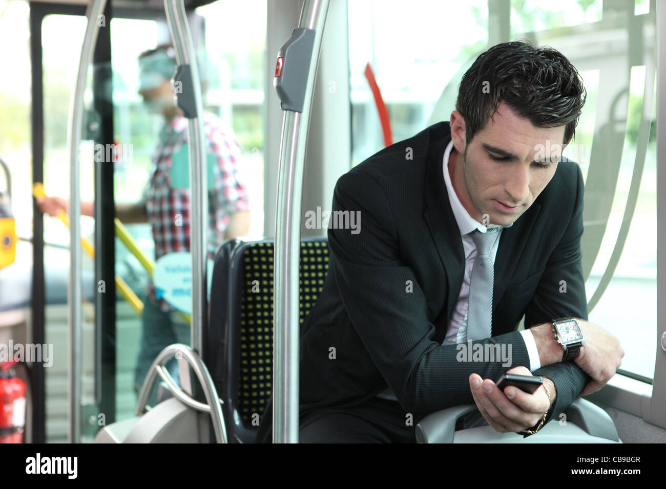 man texting in a bus Stock Photo - Alamy