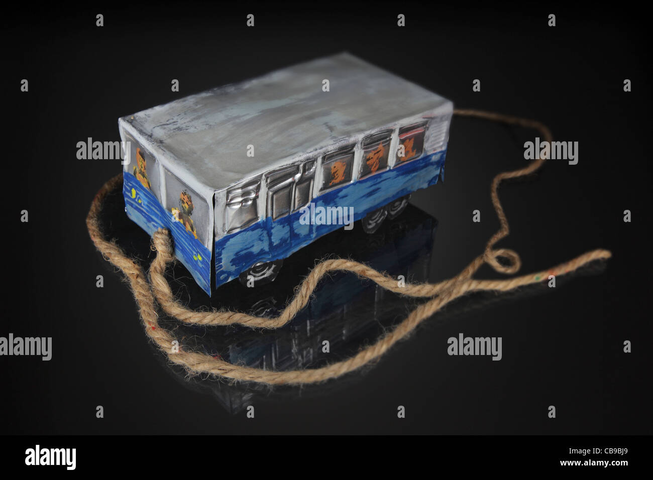 A minimalist toy bus built DIY. A rope is attached to the toy Stock ...