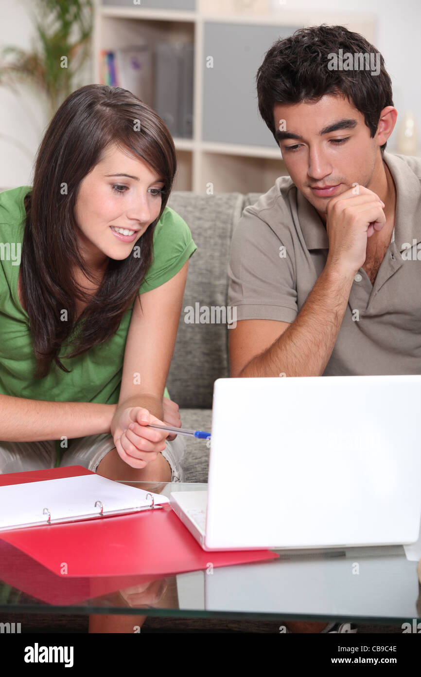 Students doing homework on laptop Stock Photo - Alamy