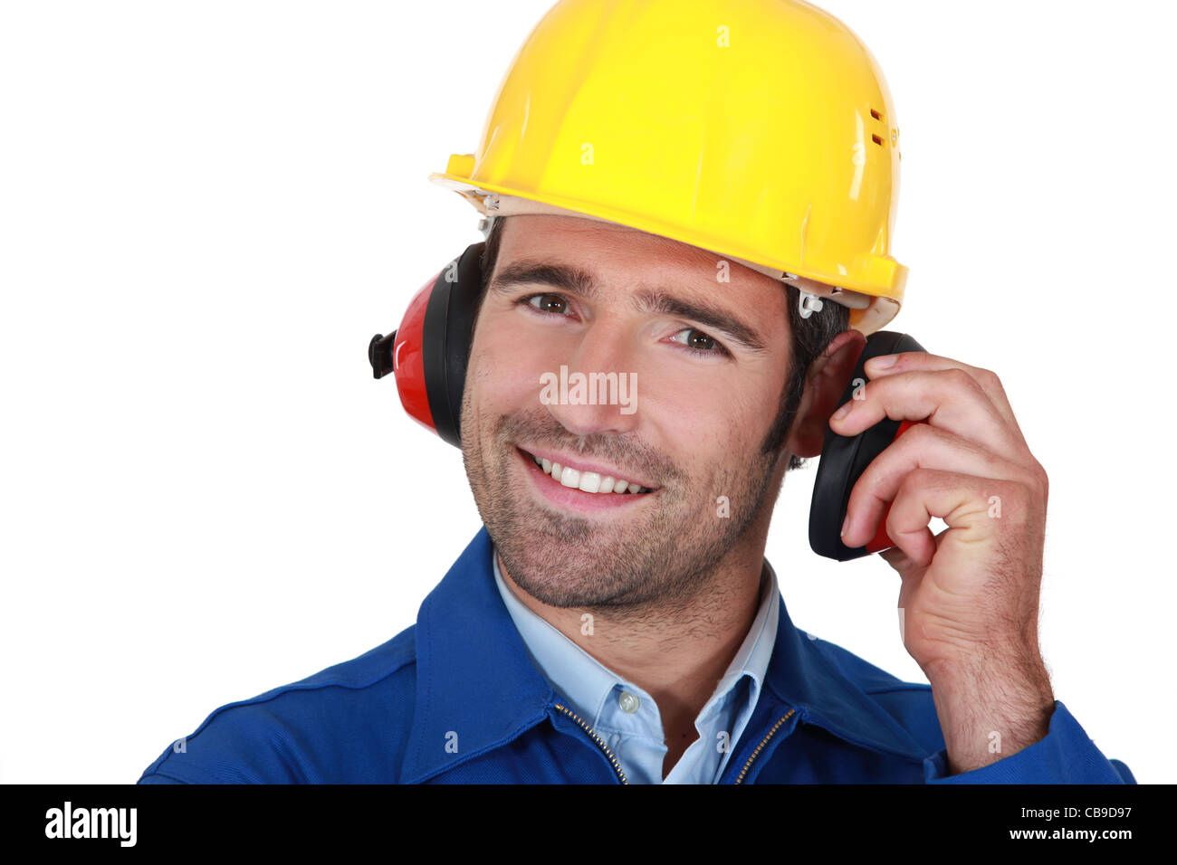 Happy builder wearing ear protection Stock Photo - Alamy