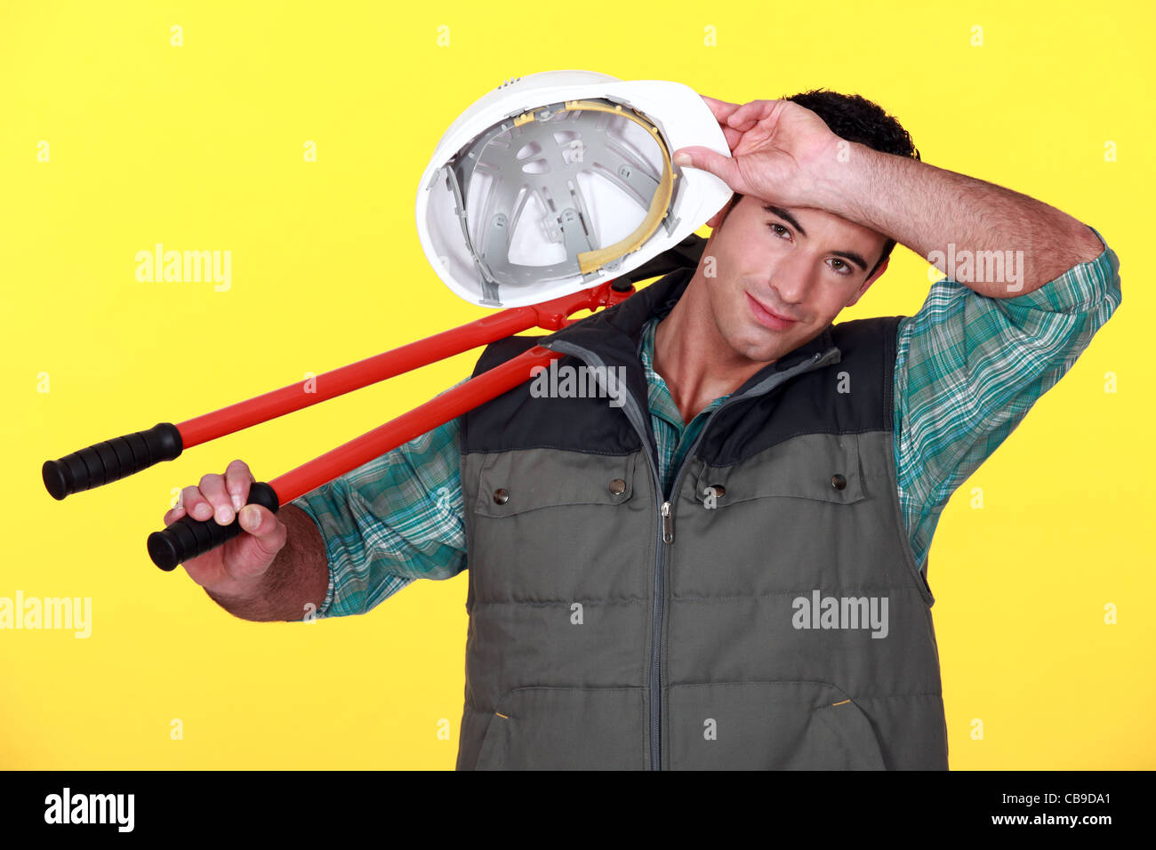 Construction worker wiping the sweat from his forehead Stock Photo - Alamy