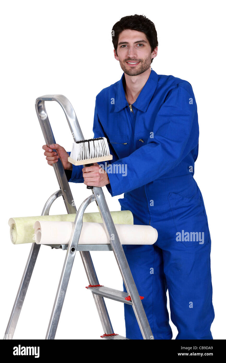 Decorator preparing to wallpaper a room Stock Photo - Alamy