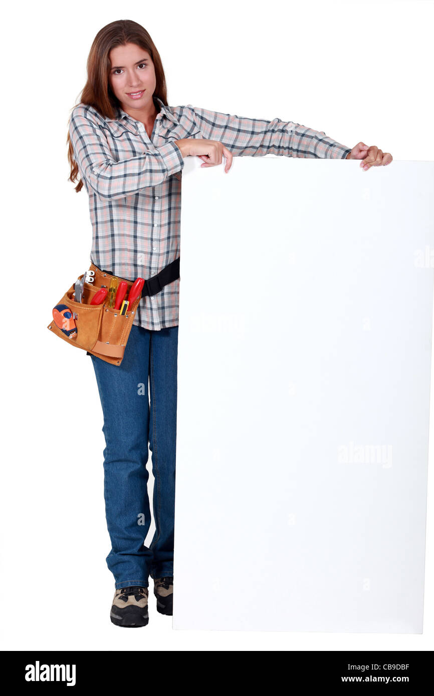 Tradesperson with a board left blank for your message Stock Photo - Alamy