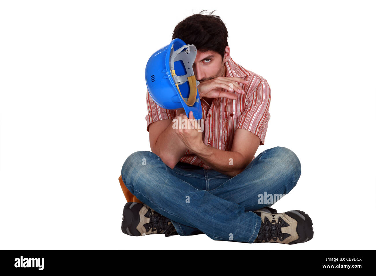 A male construction worker sitting on the floor Stock Photo - Alamy