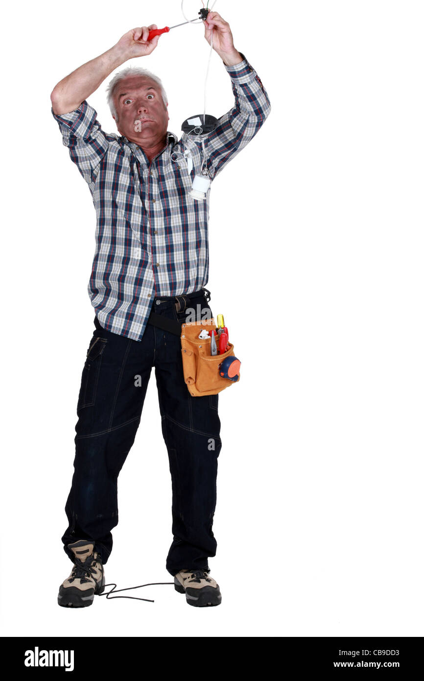 Electrocuted man fixing a light fixture Stock Photo - Alamy