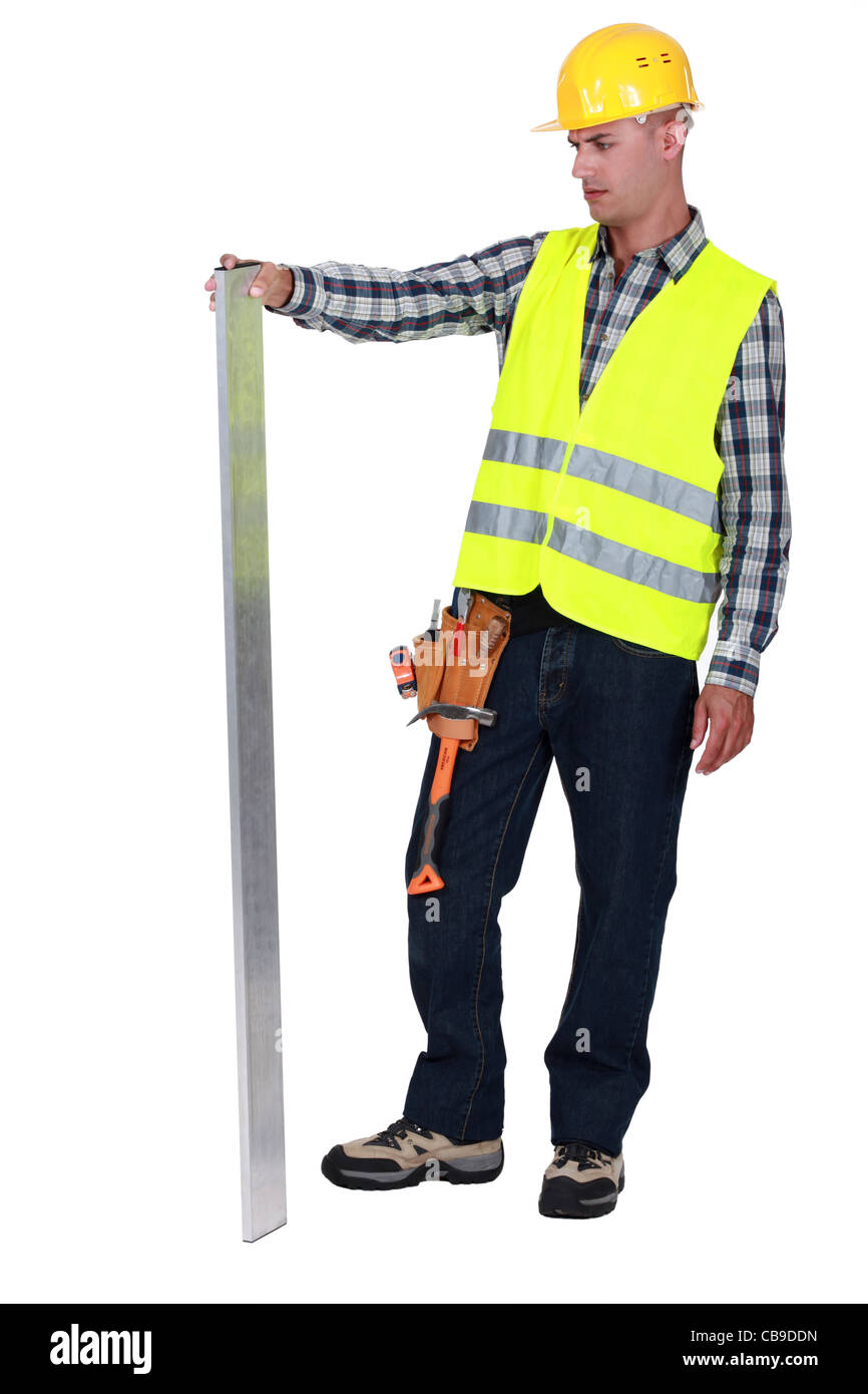 A carpenter looking at a steel plank Stock Photo - Alamy