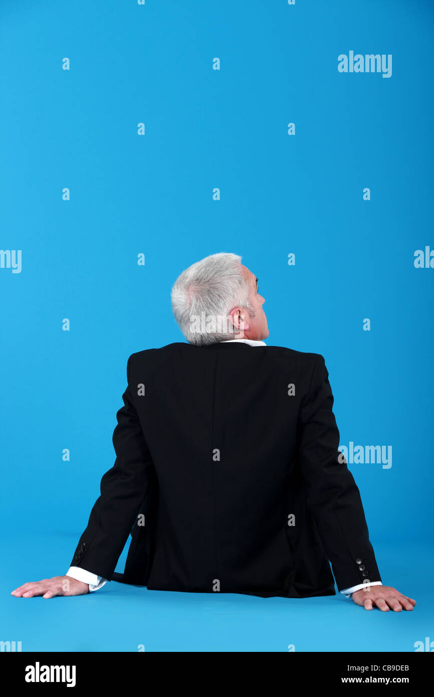 Read view of a businessman looking up Stock Photo - Alamy