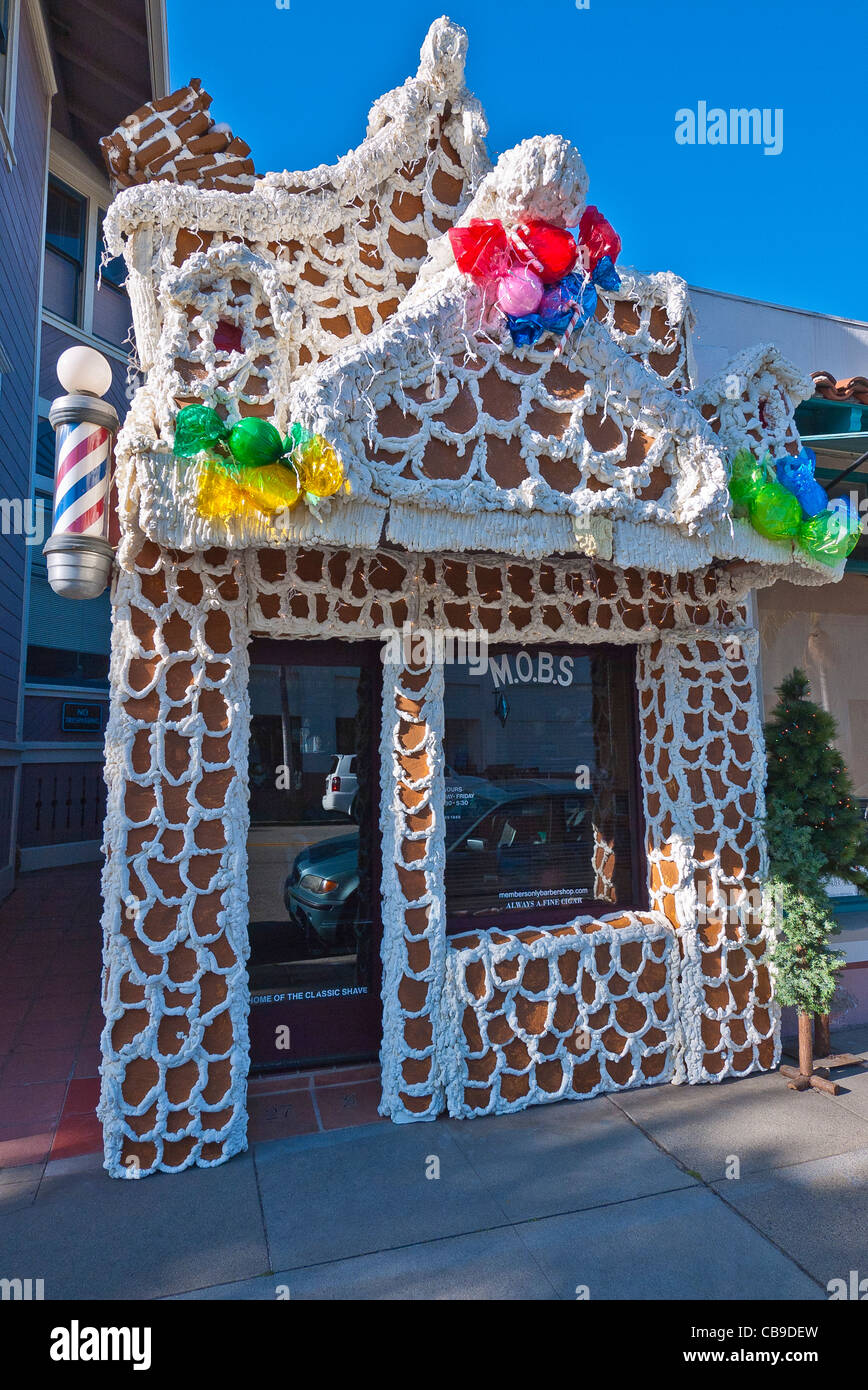 A tiny barber shop building decorated as a full-sized gingerbread house ...