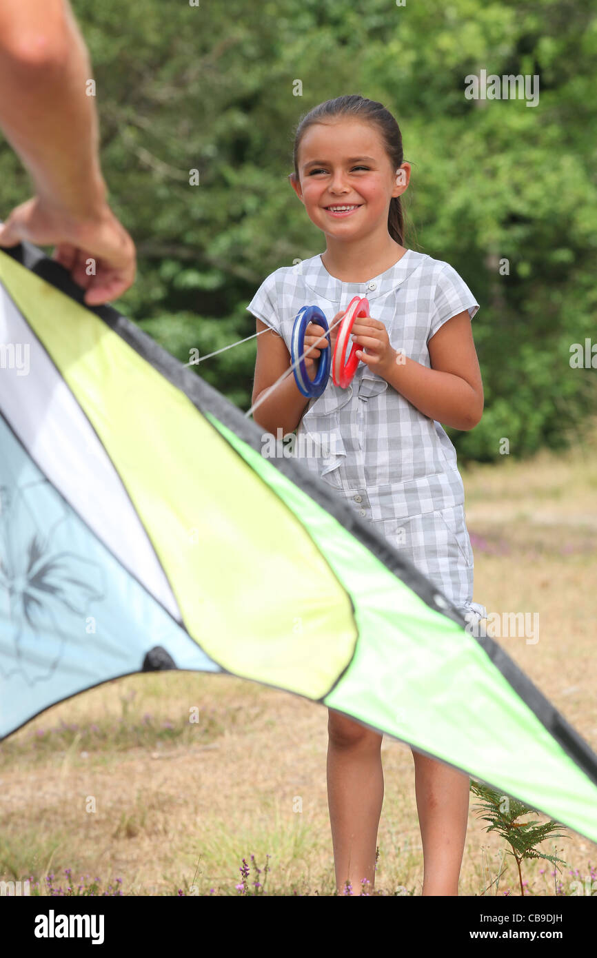 Little girl learning how to fly kite Stock Photo - Alamy