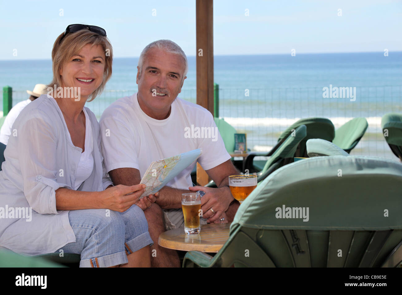 Couple having a drink on holiday Stock Photo - Alamy