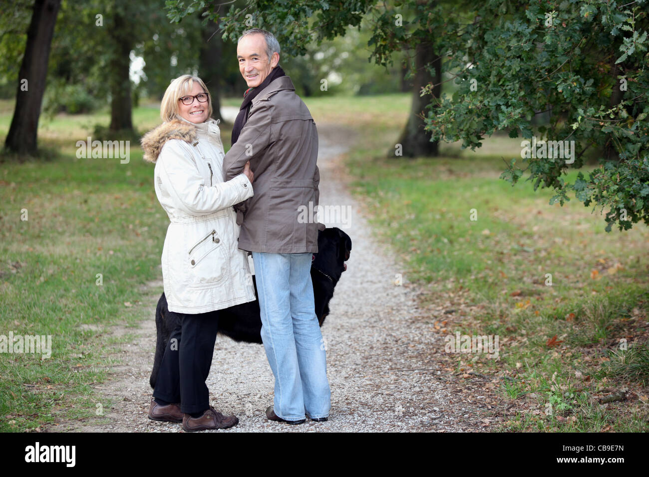 Older couple strolling through a park Stock Photo - Alamy