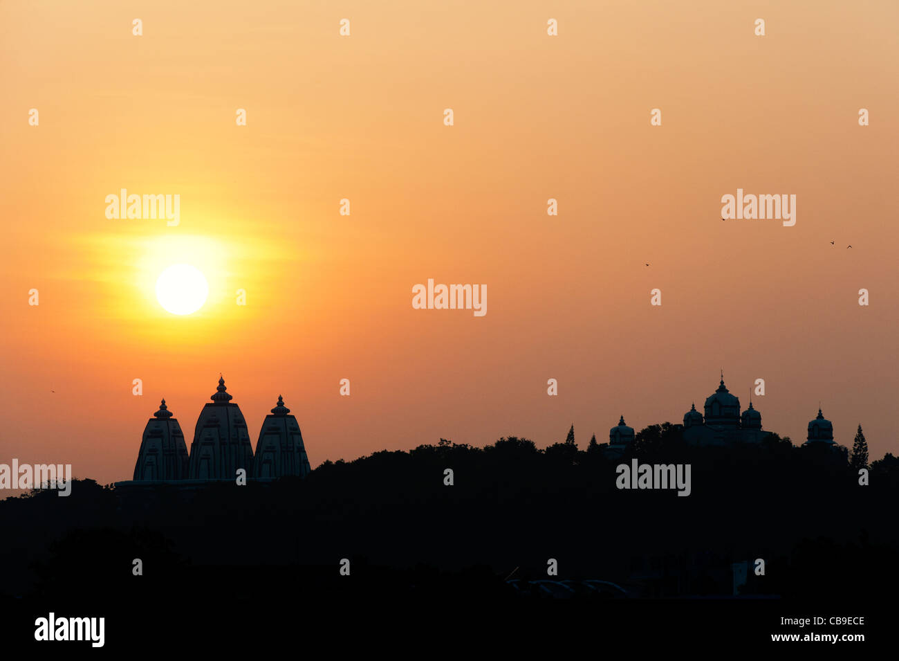Sunrise over Indian buildings in Puttaparthi . Silhouette. Andhra ...