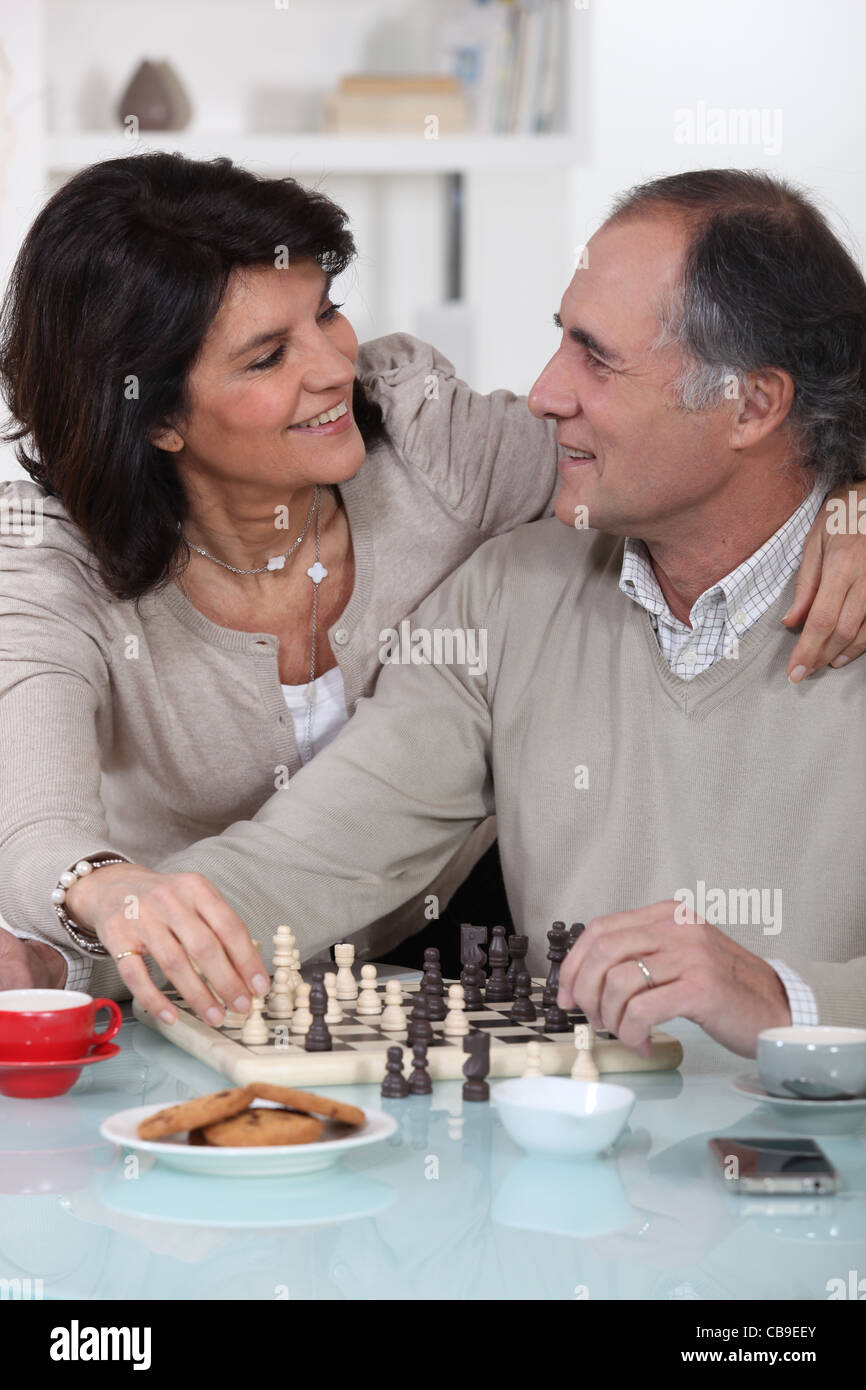 Loving couple playing chess together Stock Photo - Alamy