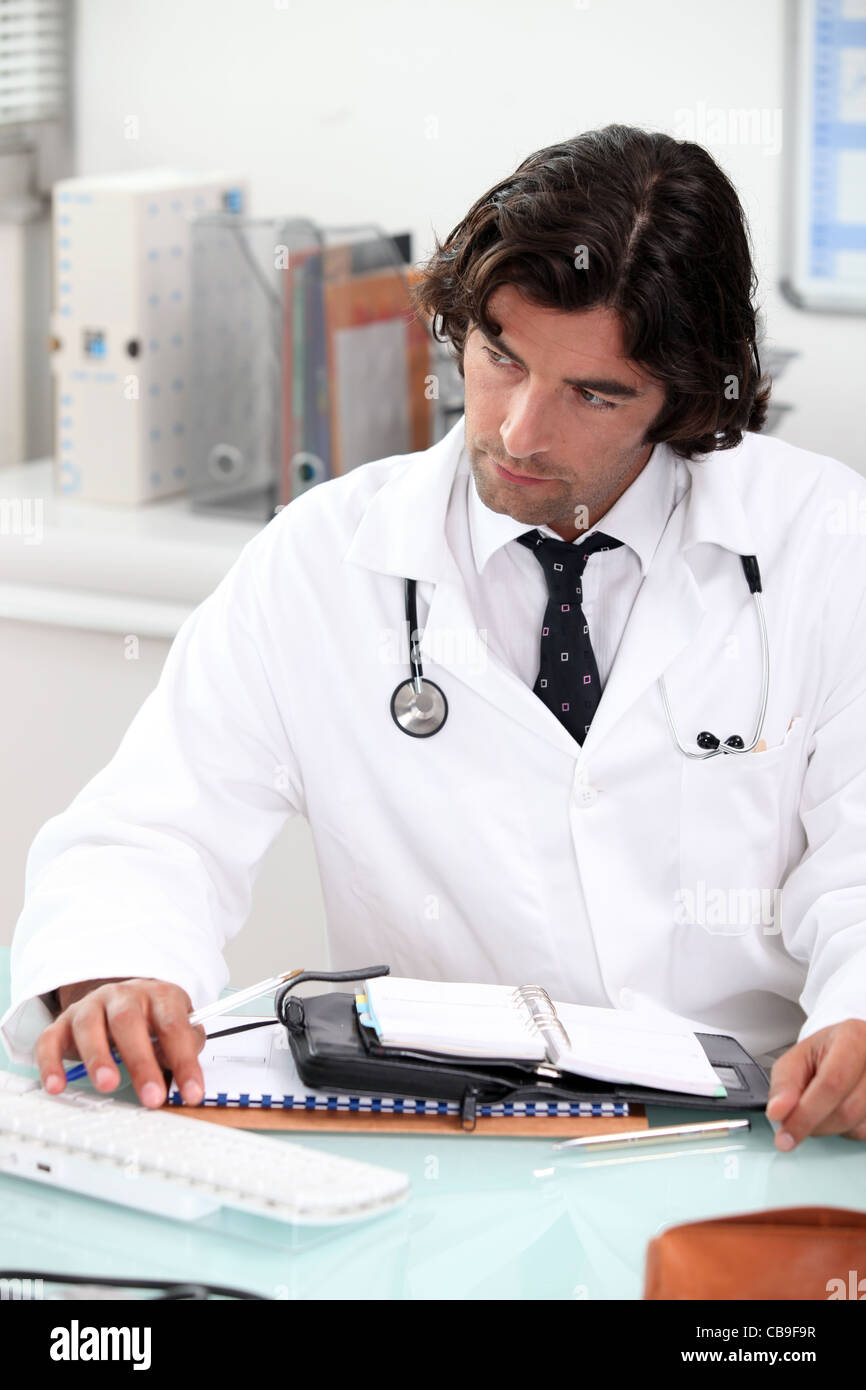 portrait of a doctor at desk Stock Photo - Alamy