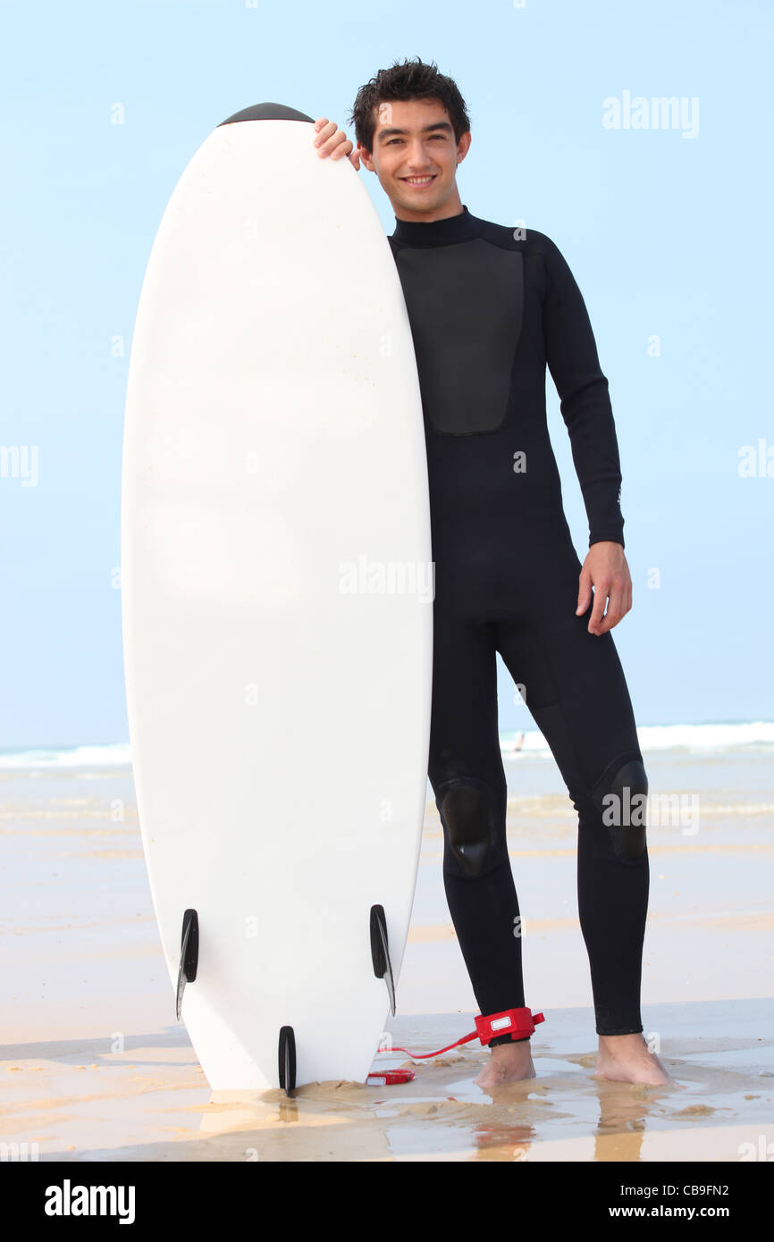 young surfer posing with board Stock Photo - Alamy