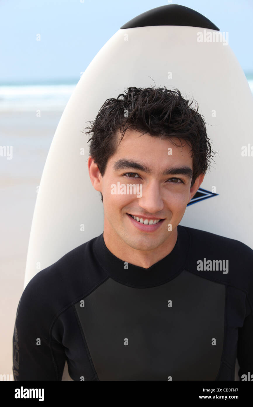 Young male surfer with his board Stock Photo - Alamy