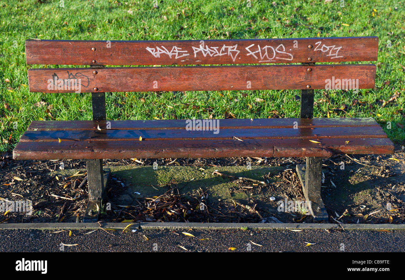 A wooden bench with graffiti Stock Photo - Alamy