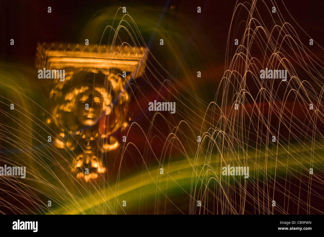An image of lights in movement an golden bust on wall Stock Photo - Alamy