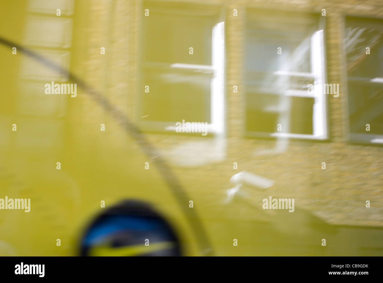 Reflection of building in yellow shop window Stock Photo - Alamy