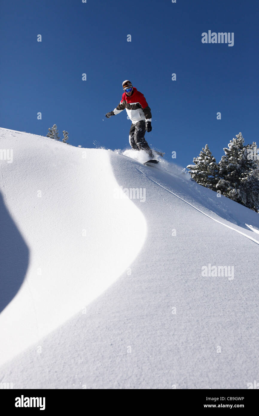 Man snowboarding downhill Stock Photo - Alamy