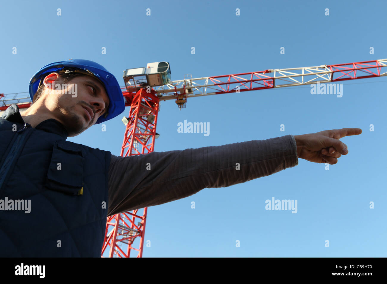 A construction worker showing directions Stock Photo - Alamy