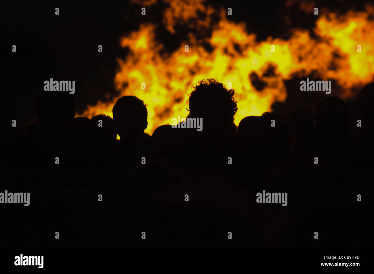 Crowd of people in front of fire Stock Photo - Alamy