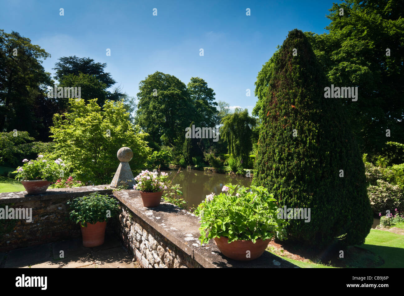 A walled terrace with planted terracotta pots overlooking the ...