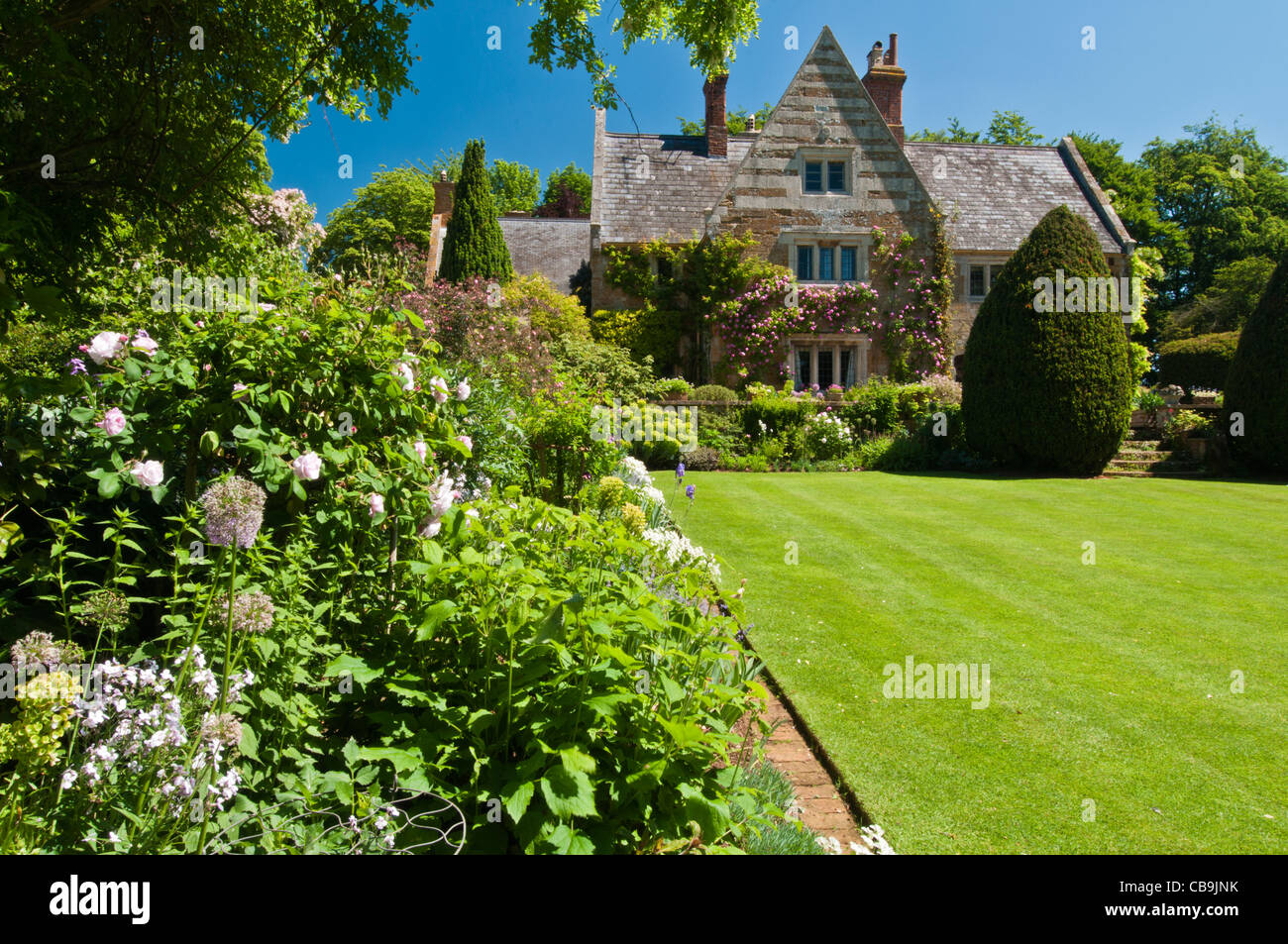 A view of Coton Manor beside the Acacia border and a well-manicured ...