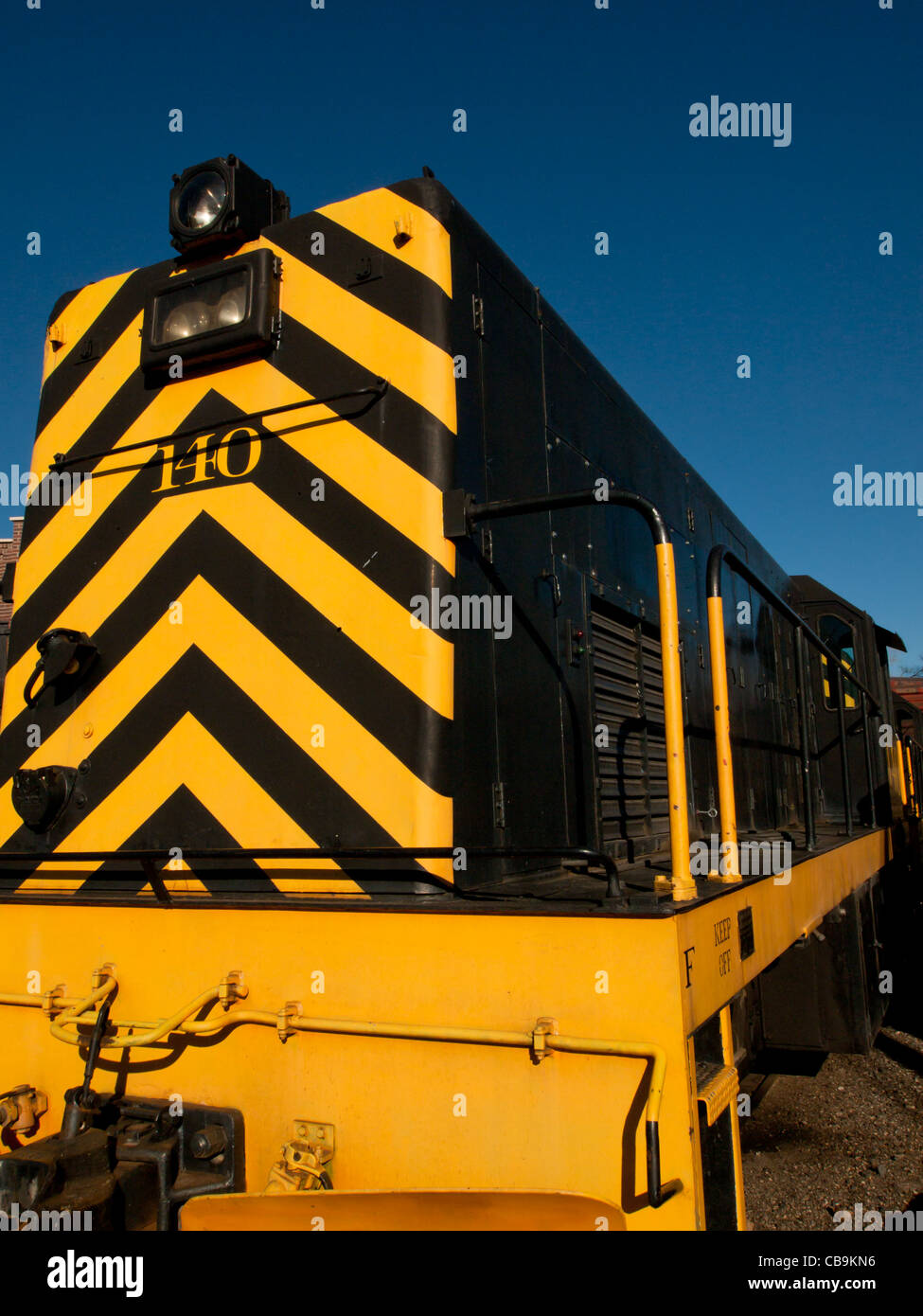 Vintage yellow locomotive at front of the roundhouse Stock Photo - Alamy