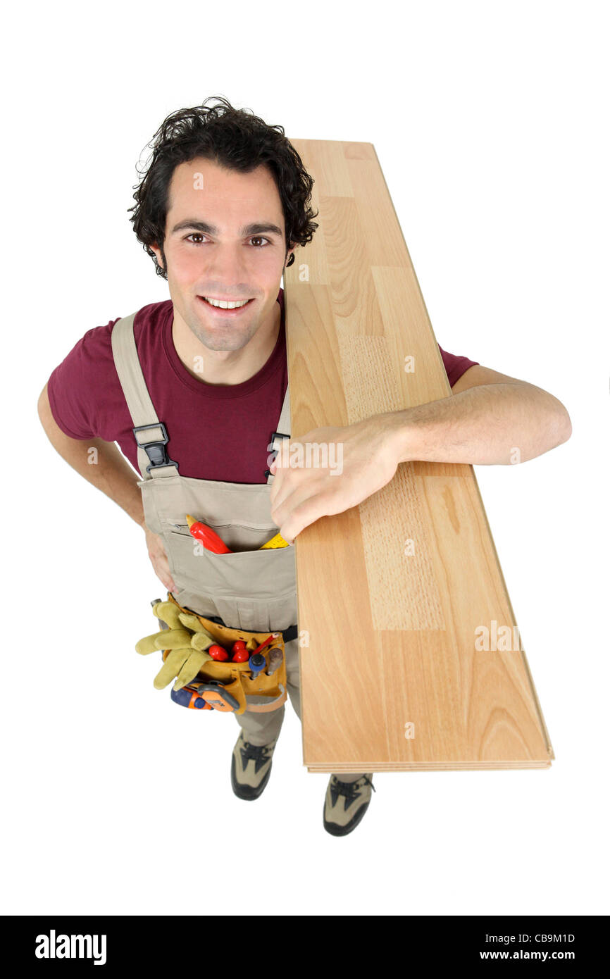 Happy woodworker carrying plank standing isolated on white background ...