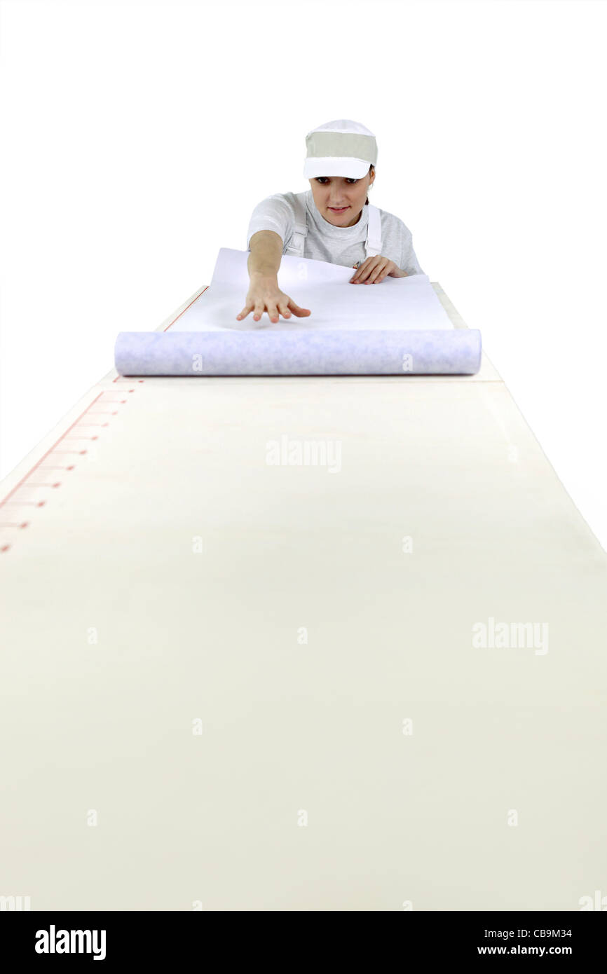 Woman unrolling wall paper Stock Photo - Alamy