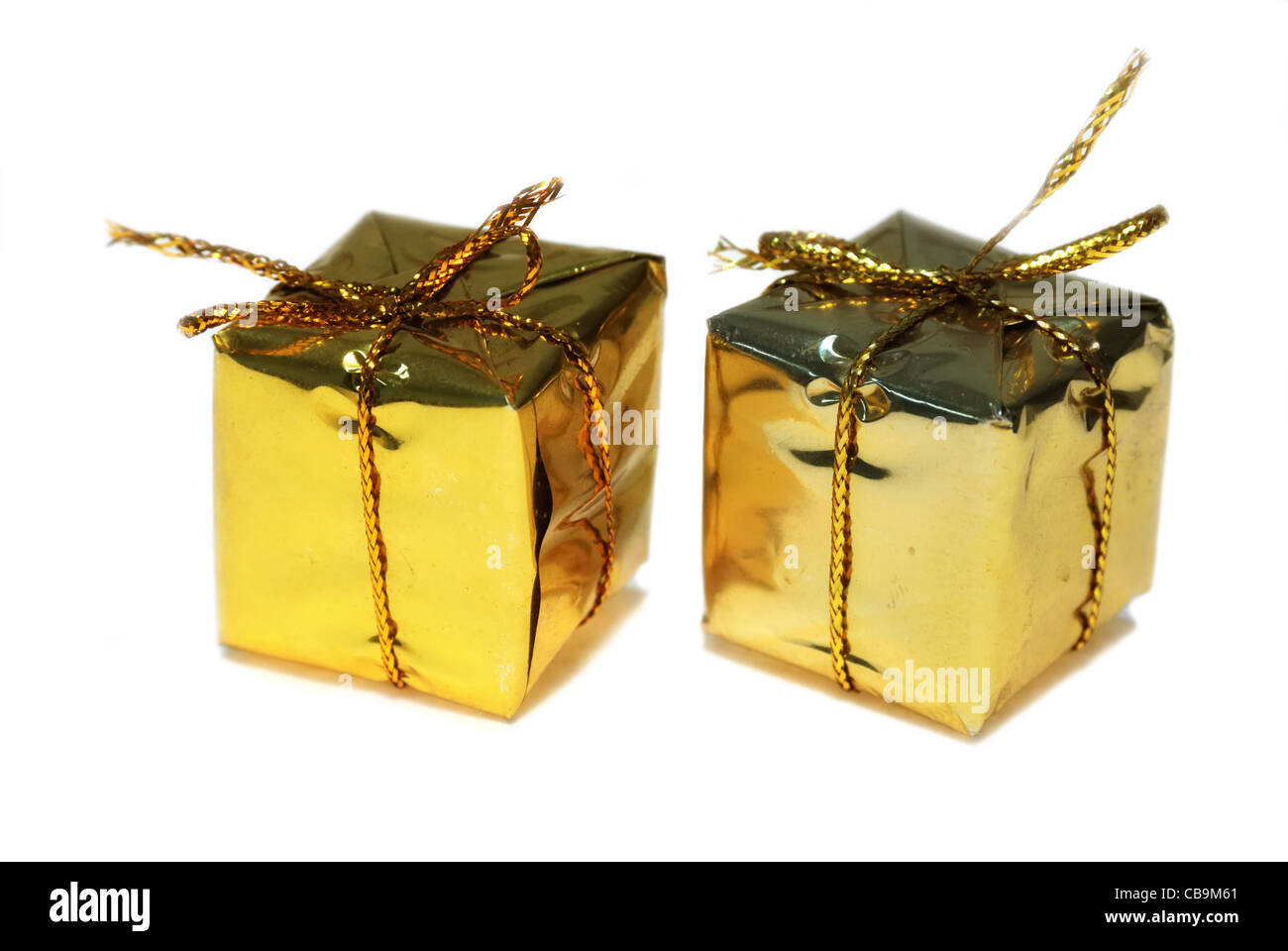 Two golden gift boxes isolated on white background Stock Photo - Alamy