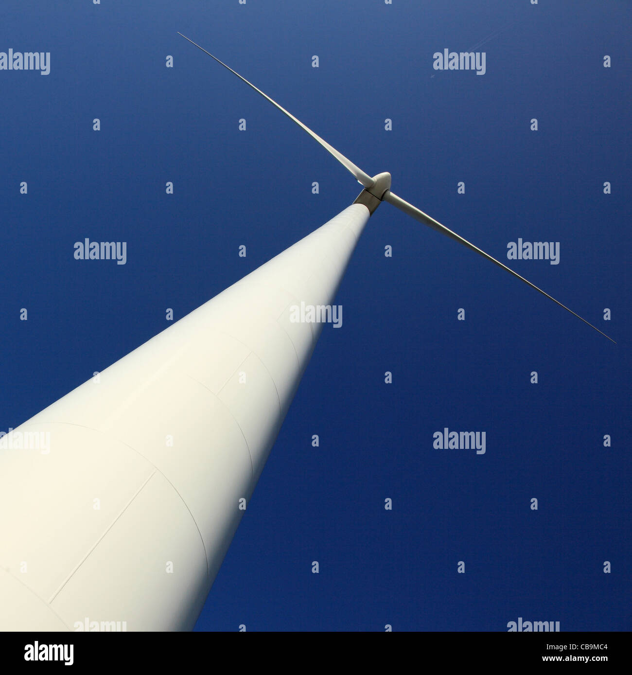 looking up to wind turbine and blue sky Stock Photo - Alamy