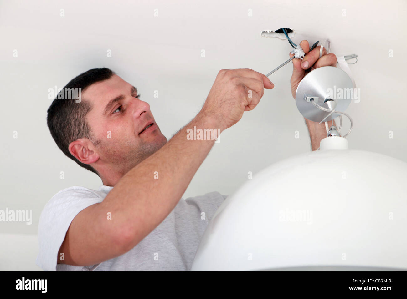 Man fixing light at home Stock Photo - Alamy